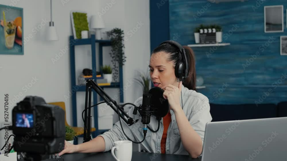 Popular digital content creator sitting at home studio desk while ...