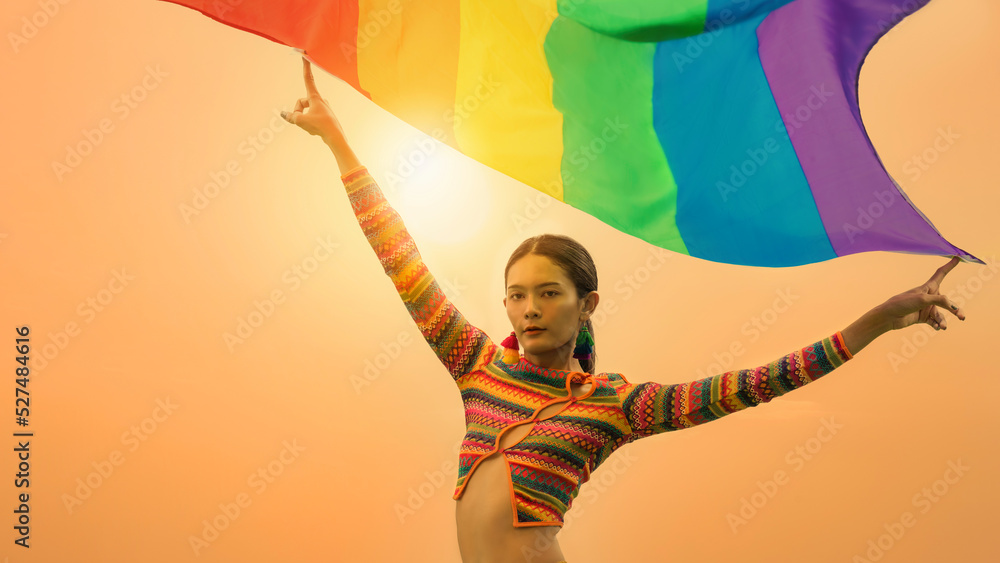portrait of asian transgender person with rainbow pride flag to ...