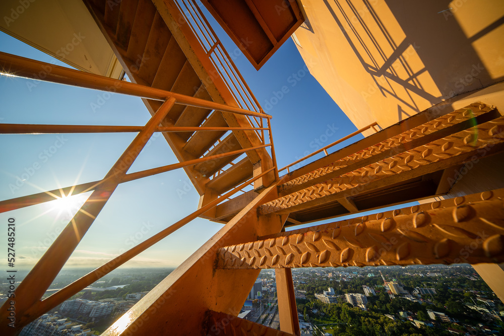 Fire escape stairs mounted to the outside in morning. Emergency exit ...