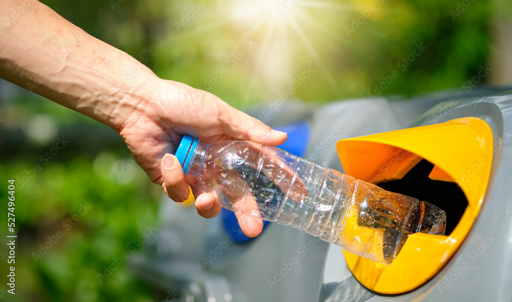 Please dispose of plastic bottle into the tank. A man throw rubbish in ...