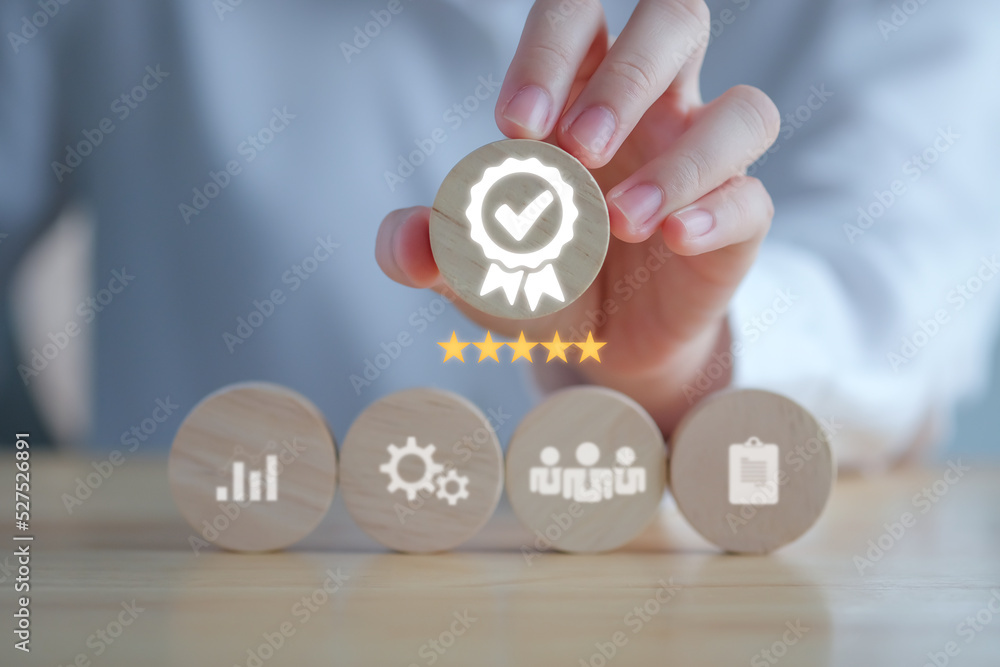 Businessman hand holding sign of the top service Quality assurance with ...