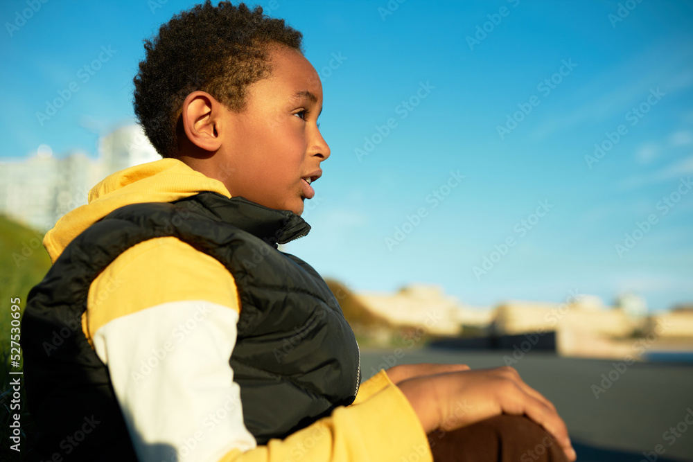 Side view closeup portrait of african american boy kid sitting on ...
