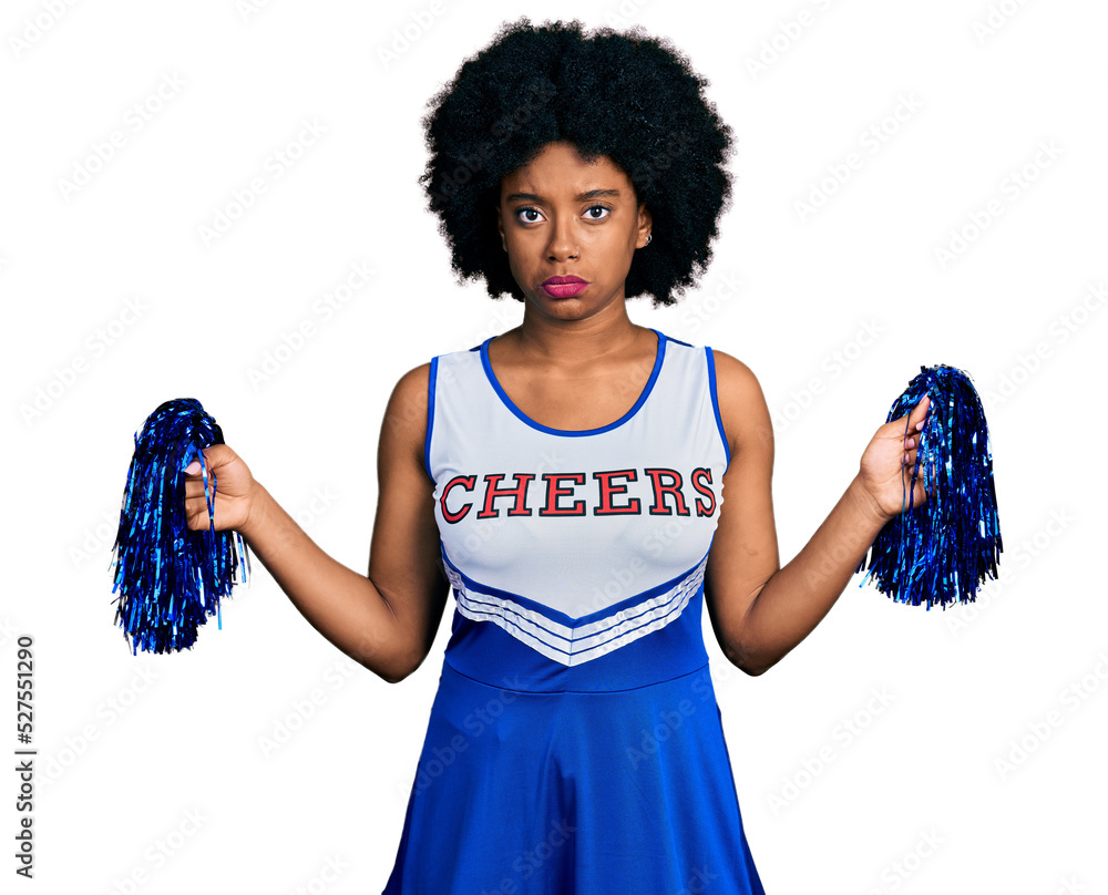 Young african american woman wearing cheerleader uniform using pompom ...