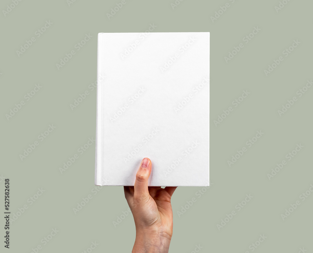 Hand holding closed book mockup with white cover. Novel, encyclopedia ...