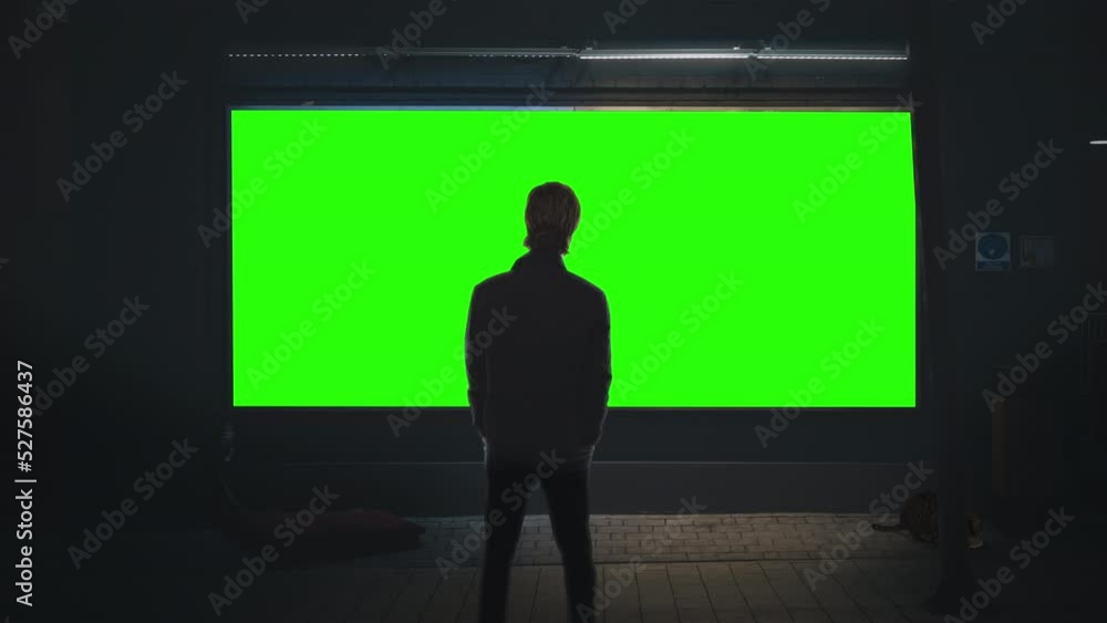 Street Billboard Man Looking Green Screen Night Time. Man standing in ...