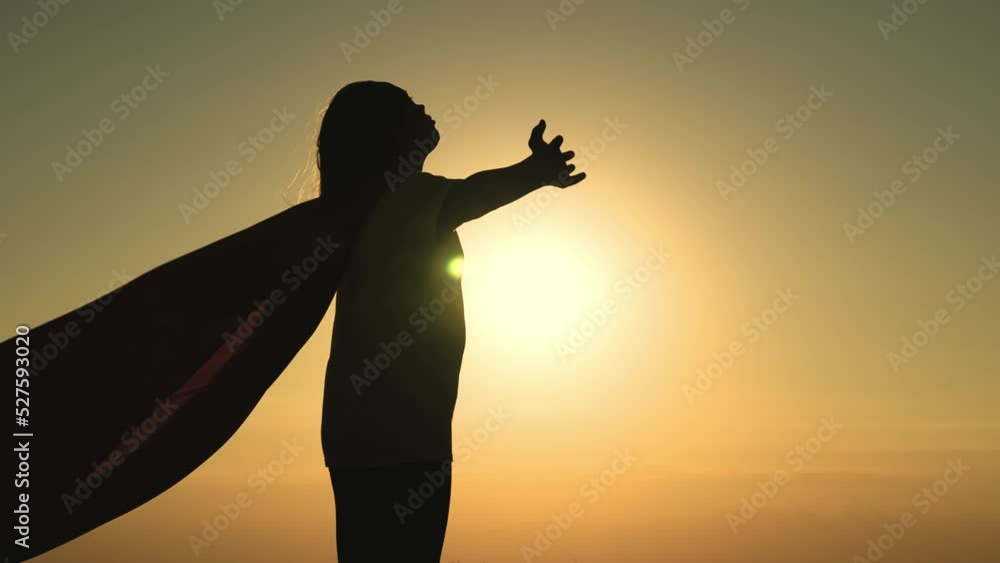 girl superhero with long hair red cape wind sunset. brave superhero ...
