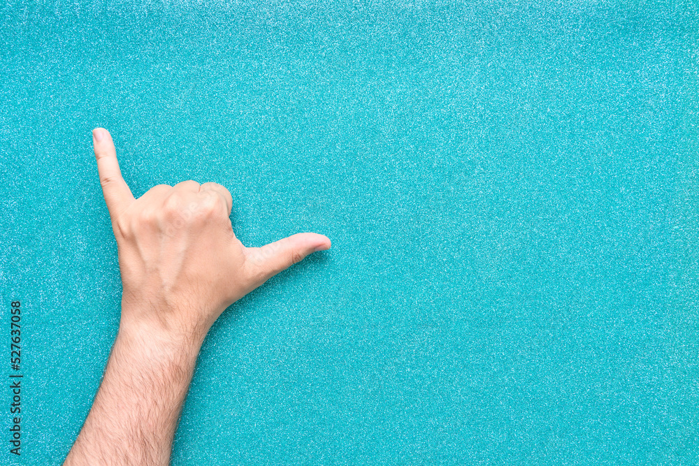 gesture with man's left hand of relaxation shaka or drink in man hand ...