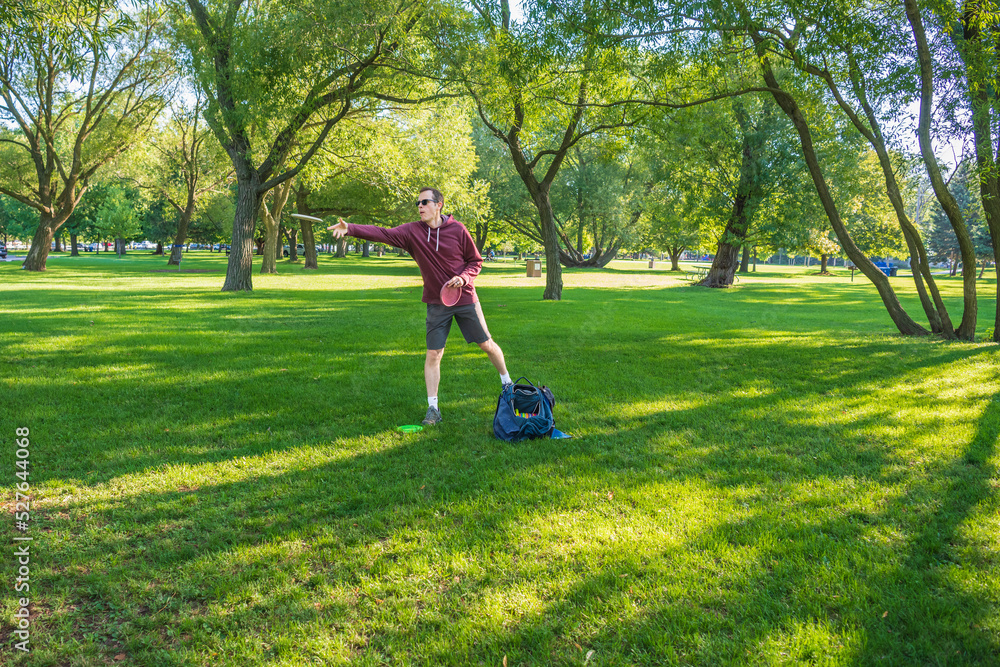 Disc golf, a flying disc sport played using rules like golf, being ...