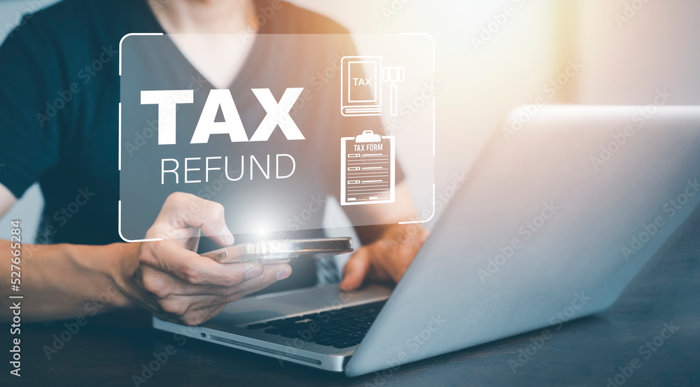 Hand using tablet with bar TAX REFUND and refund tax of duty taxation ...