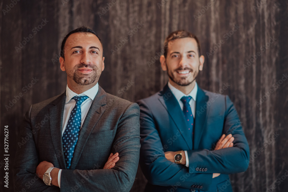 Portrait of two businessman in a suit with his arms crossed in a modern ...