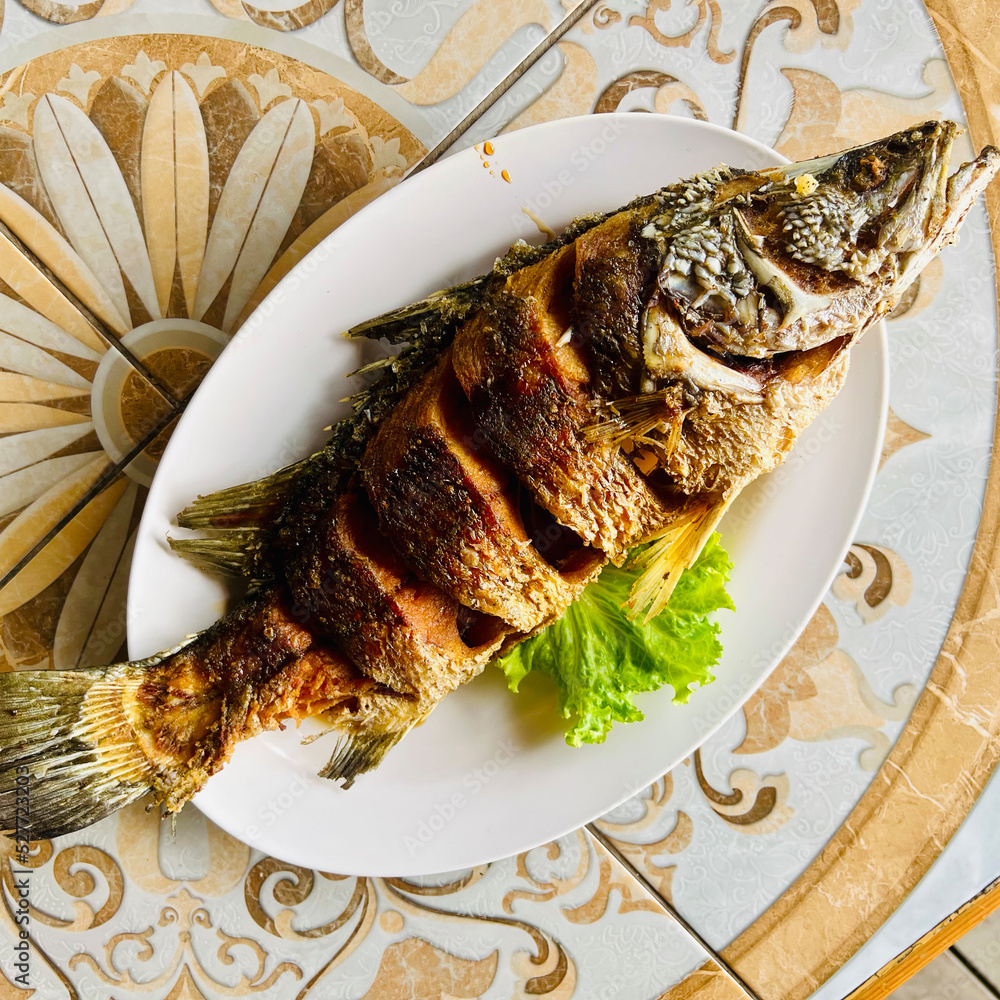 Deep fried sea bass with fish sauce called "Pla Ga Pong Tod Nam Pla" in ...