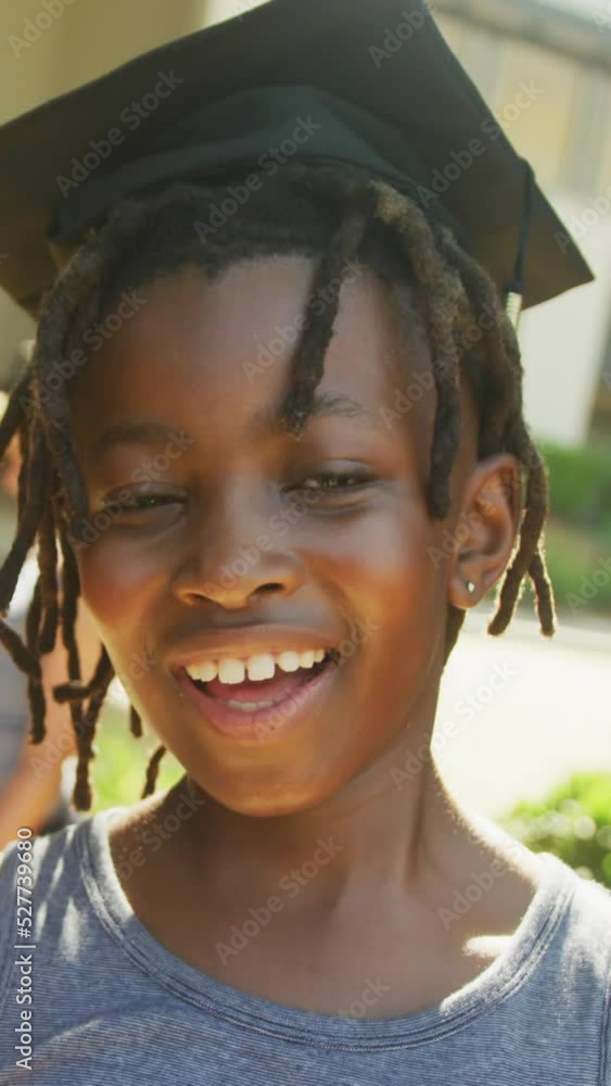 Video of happy african american boy wearing graduation hat and holding ...