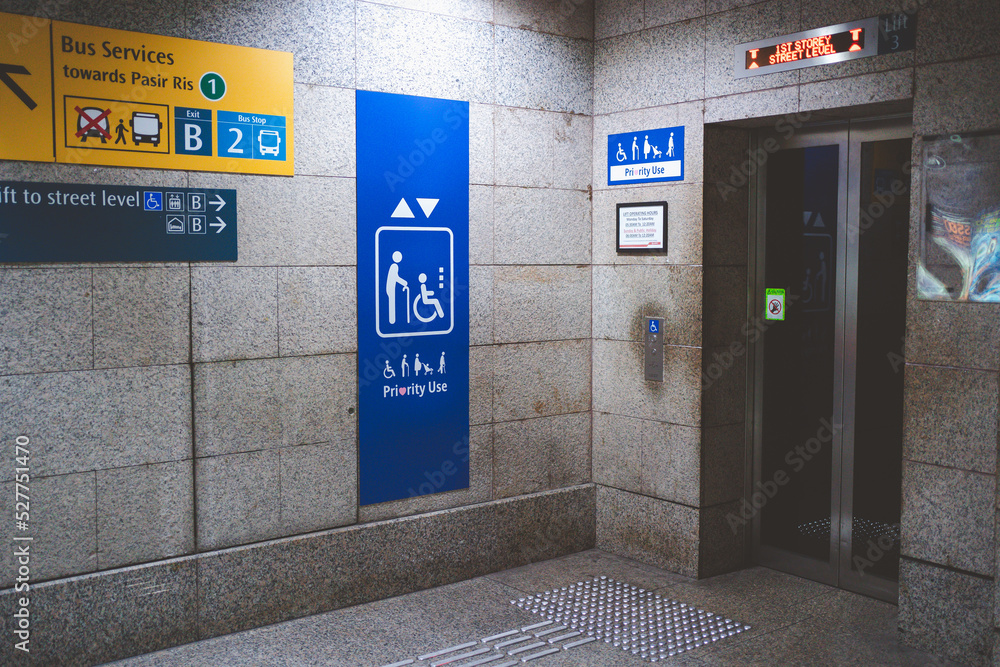 Signs priority use elevator in MRT Singapore. Stock Photo | Adobe Stock