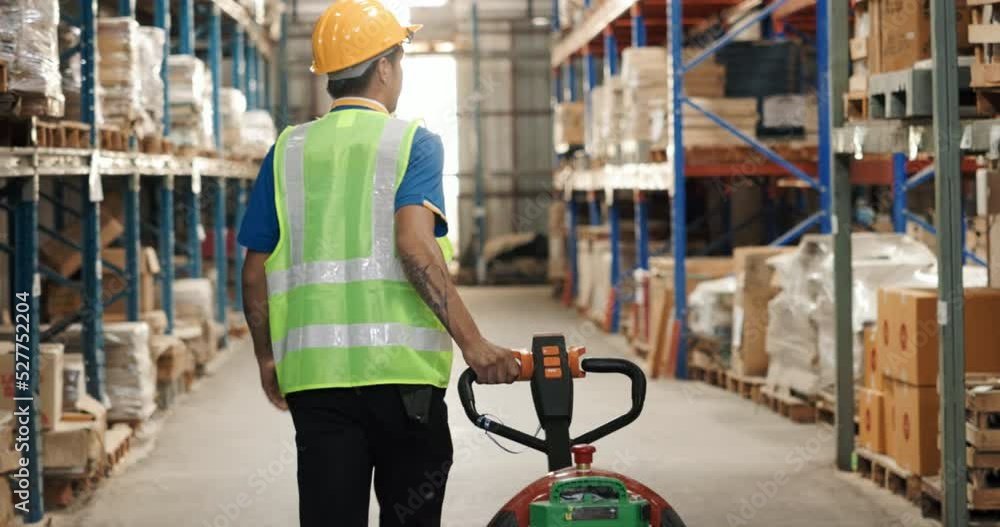 Asian man, manual worker use hand to pull, drag or lug pallet jack in ...