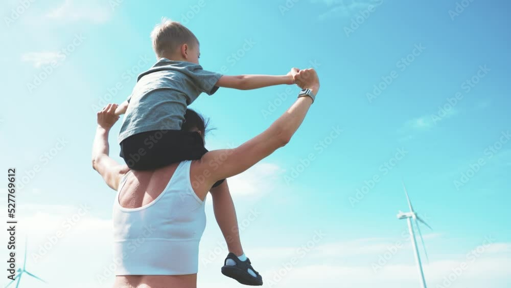 Video „View back young mother with his little son sitting on parent ...