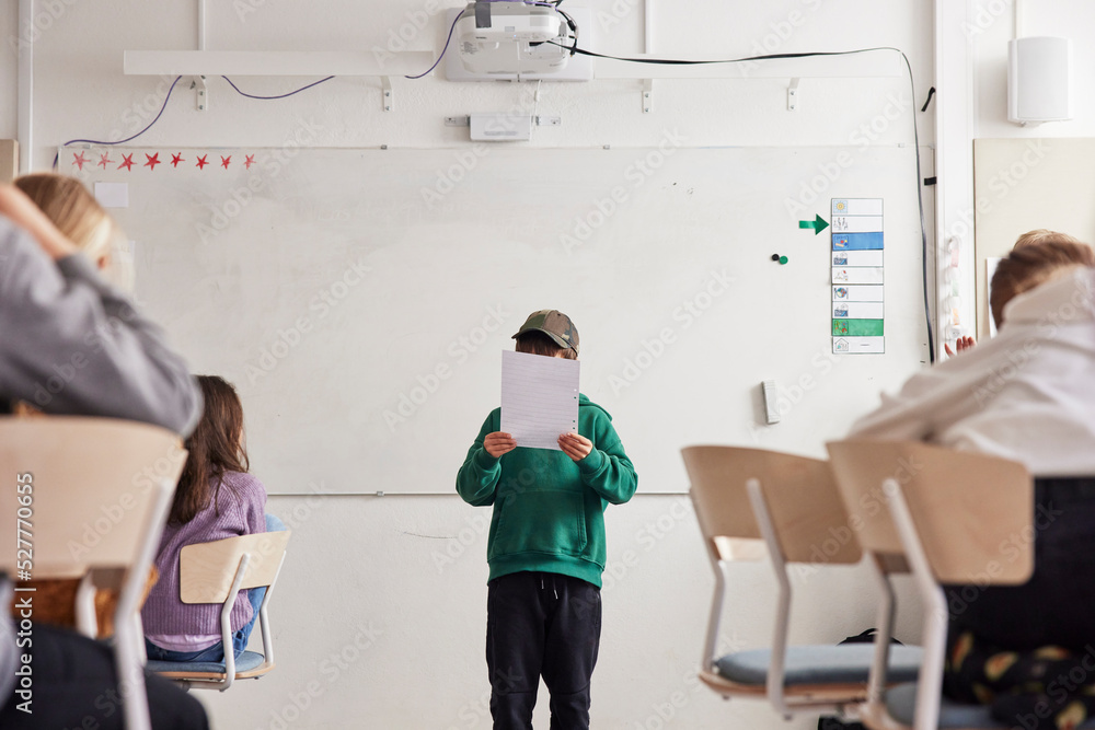 Boy reading in front of class Stock Photo | Adobe Stock