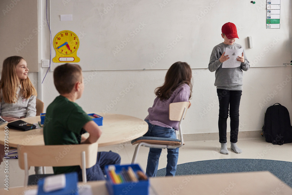 Boy reading in front of class Stock Photo | Adobe Stock