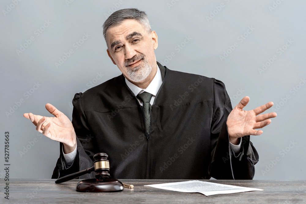 Judge spreads his arms to the side with disappointment judge's gavel ...