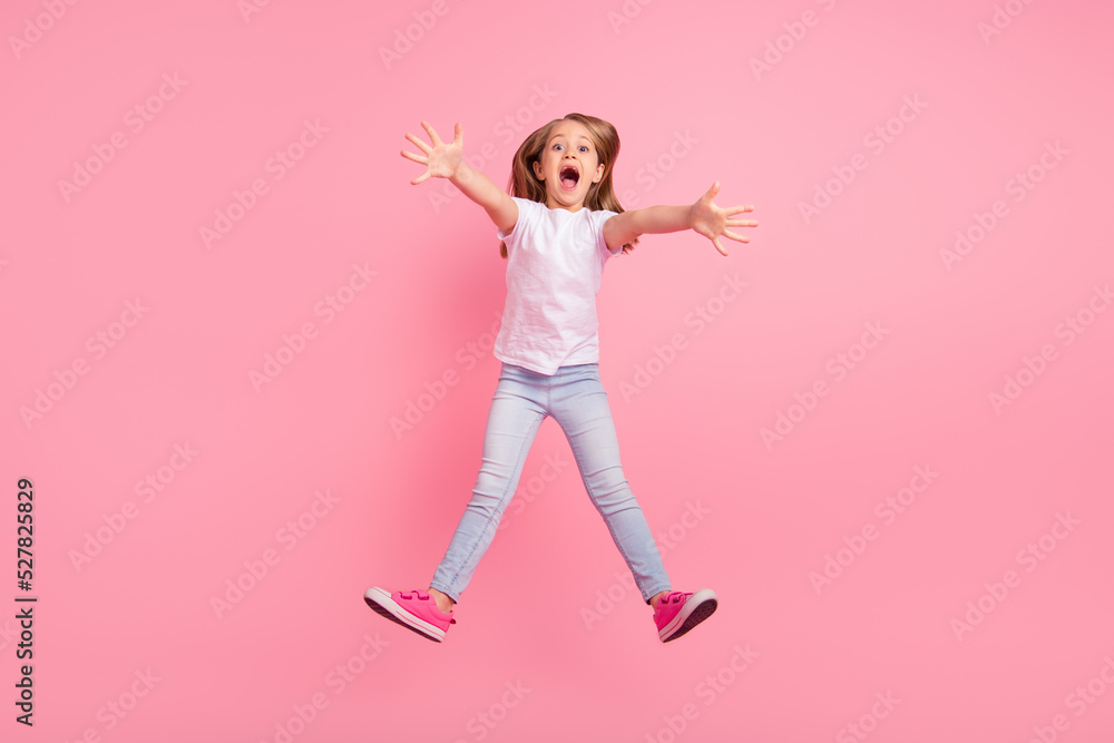 Full size photo of energetic active kid jump raise hands open mouth ...