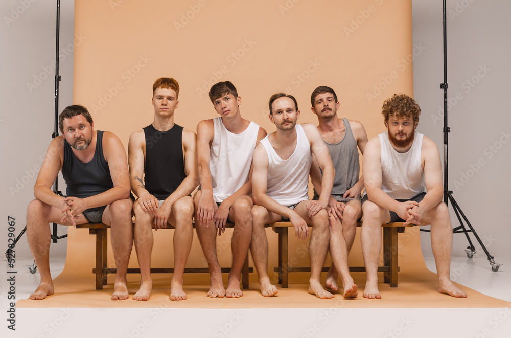 Group of emotional men of different ages having photo shoot at studio ...