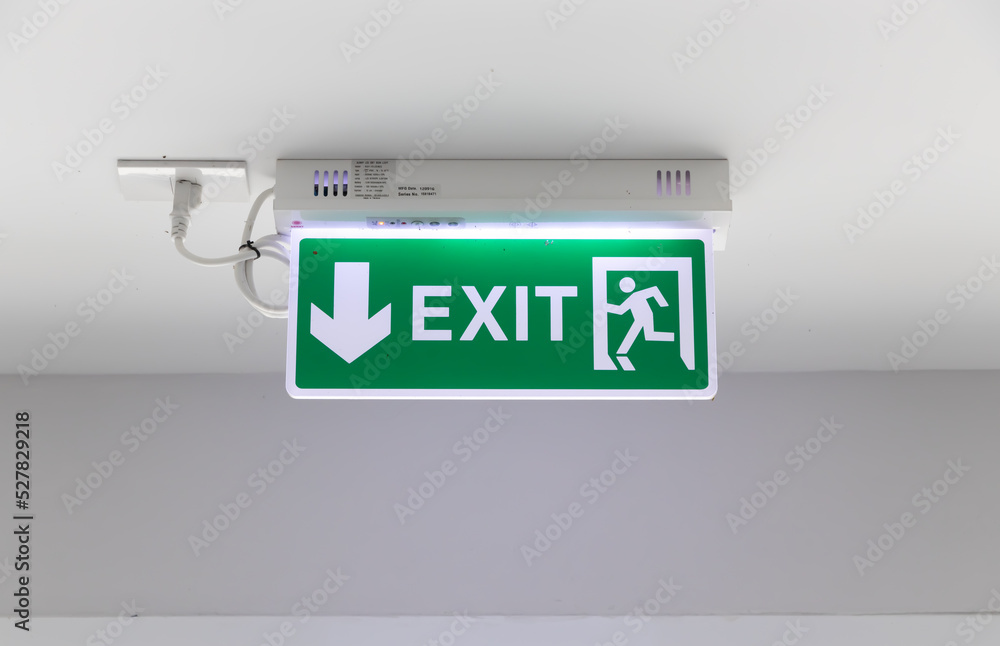 Fire exit signs installed on the wall of the building. Stock Photo ...