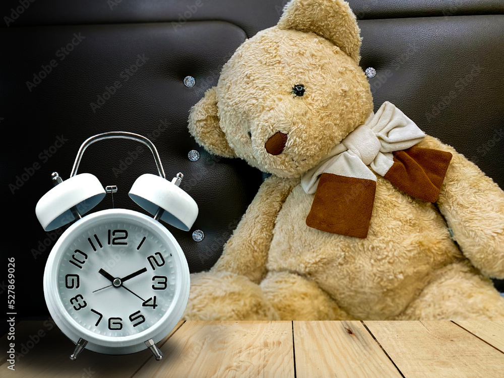 brown teddy bear sleeping in bed with alarm clock..Happy teddy sleeping ...