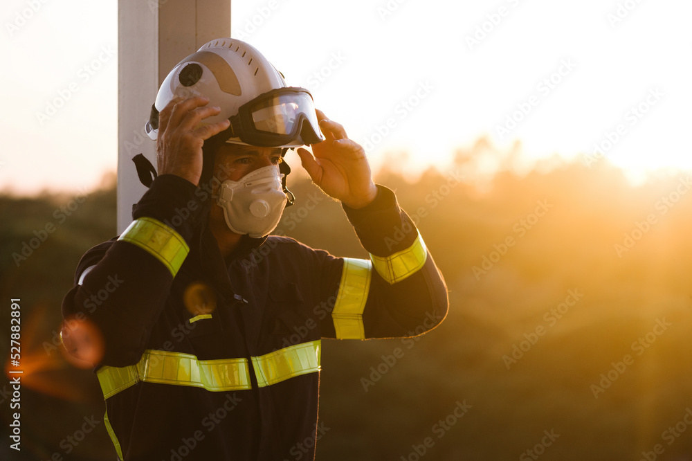 Firefighter getting dressed to start work disinfecting a buildin Stock ...