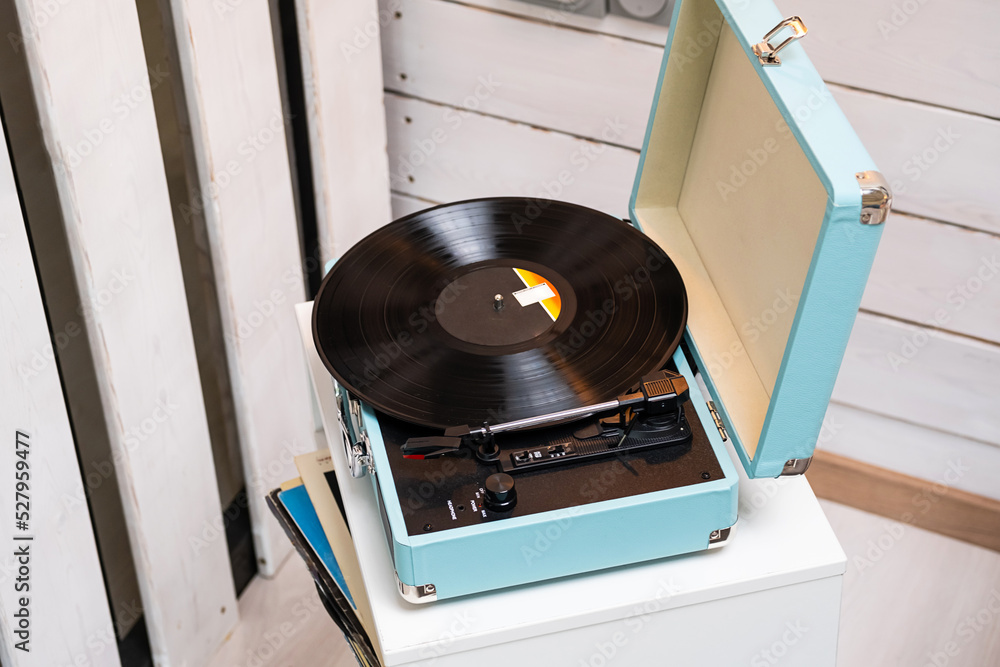 Analog vinyl record player with disc on white table. Modern turntable ...