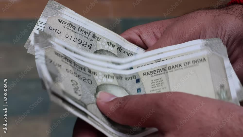 Front Shot of Indian male Counting multiple denomination of Indian ...