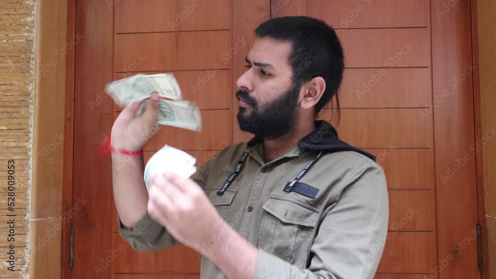 Angry man finding Fake Indian rupees. Concept shot of receiving fake ...