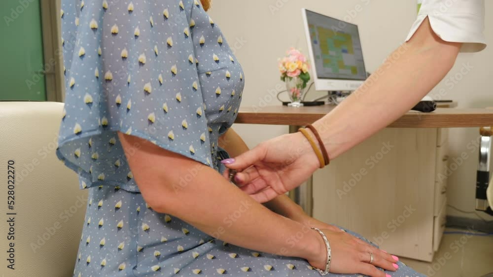 Neurologist examines female patient with needle to test sensibility ...