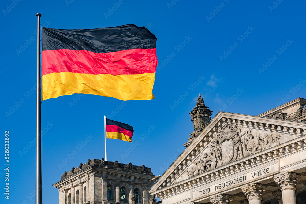 The federal flag in front of the remarkable Reichstag in Berlin as a ...
