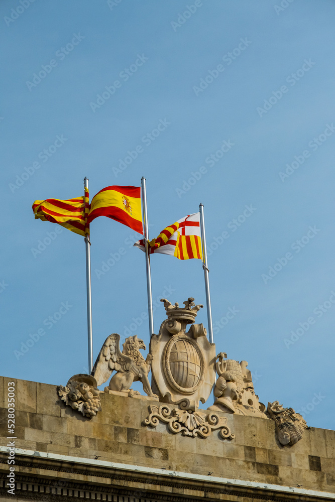 View of the flags of Barcelona, Catalonia and Spain flutter in the wind ...