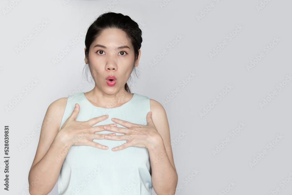Asian beautiful women raise hand touch her chest with shocked and ...
