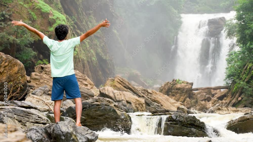 excited Screaming young man by seeing waterfall at travel destination ...