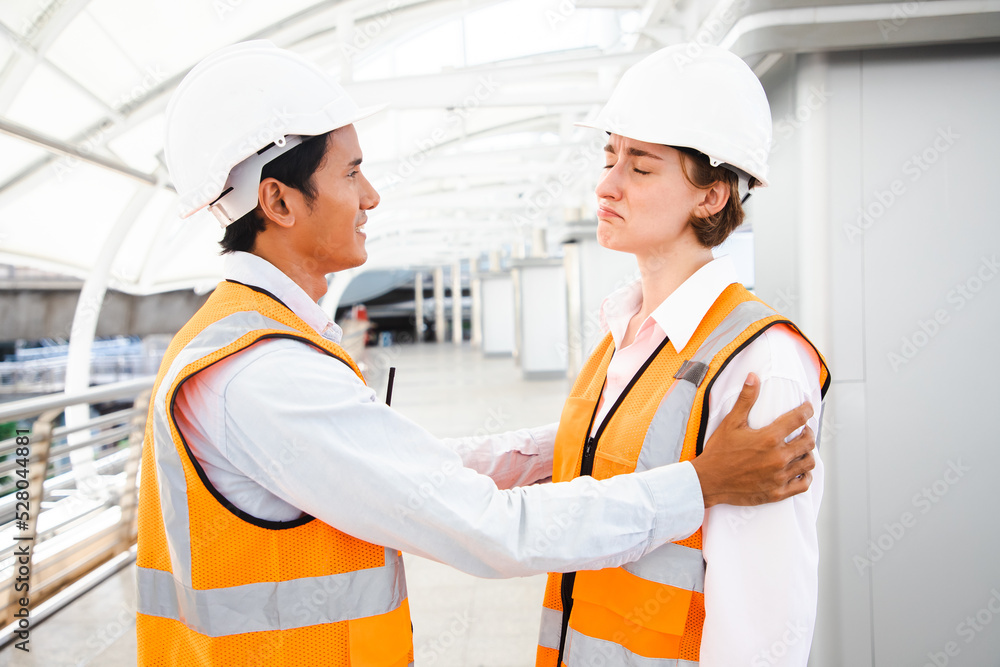 Supervisor touching worker shoulder consoling after accident in ...