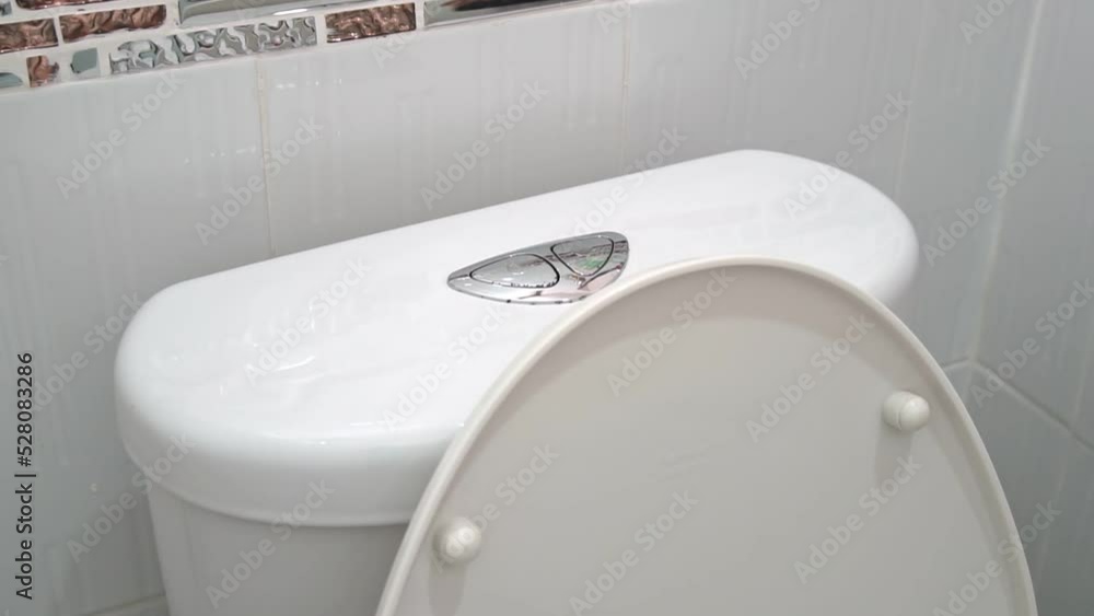 Young woman presses button in toilet with her finger. press water ...