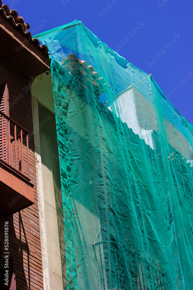 Protective net. Reconstruction of facade of historic classical ...