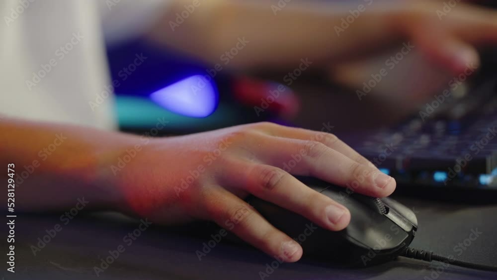 Close-up of a gamer moving the computer mouse while playing in a ...