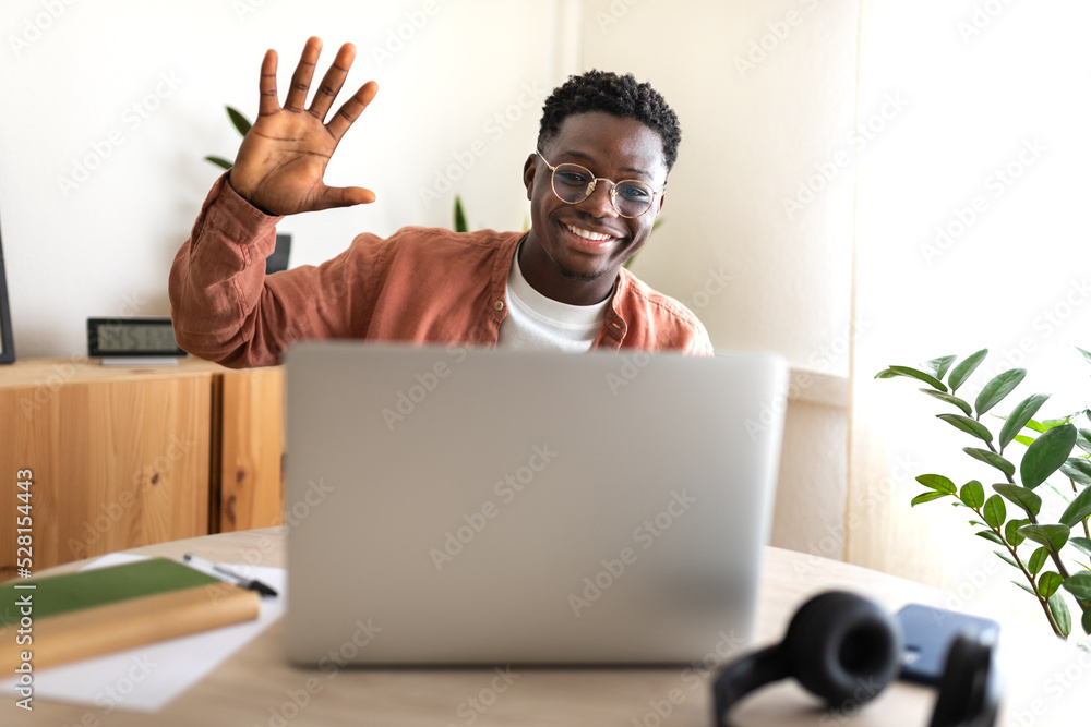 Black young man in video call taking online classes. Greeting ...