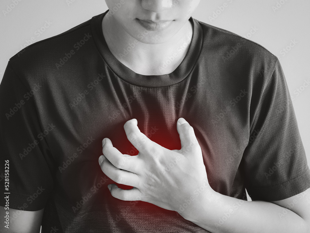 Black and white image of a man suffering from chest pain with red dots ...