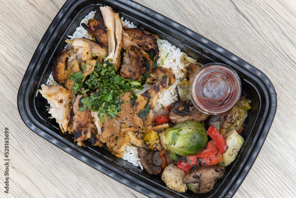 Overhead view of take out order of shawarma chicken with jasmin rice is ...