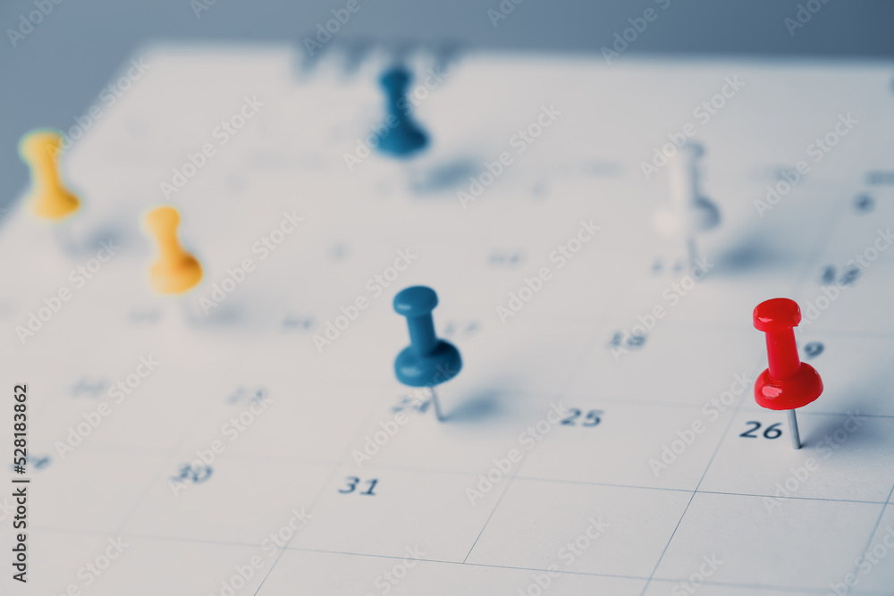 Foto de Embroidered red pins on a calendar event Planner calendar,clock ...