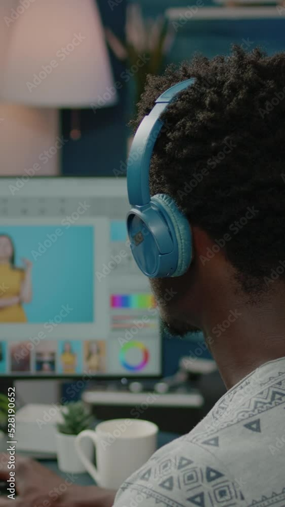 Vertical video: Photographer retouching pictures on computer and ...