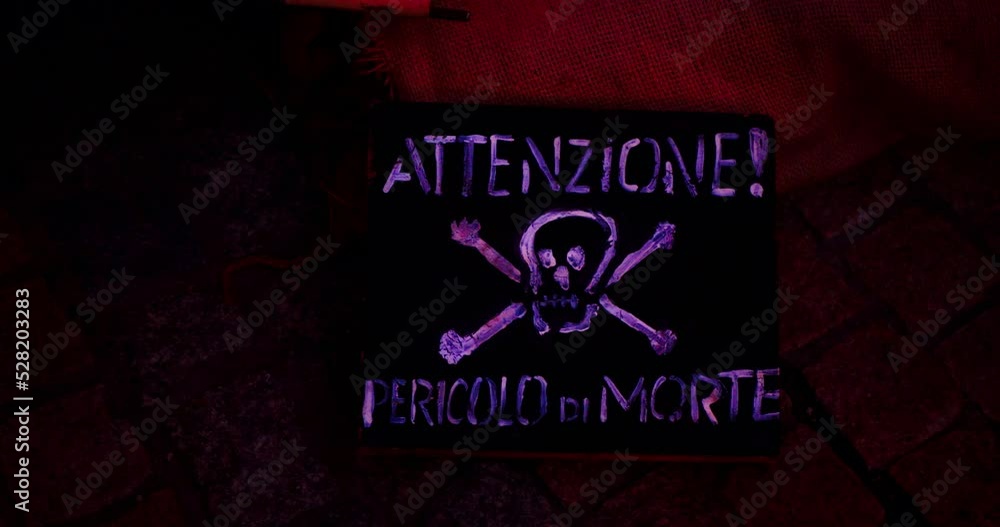 Attention! Deadly danger. Warning sign in Italian. Human skull and ...