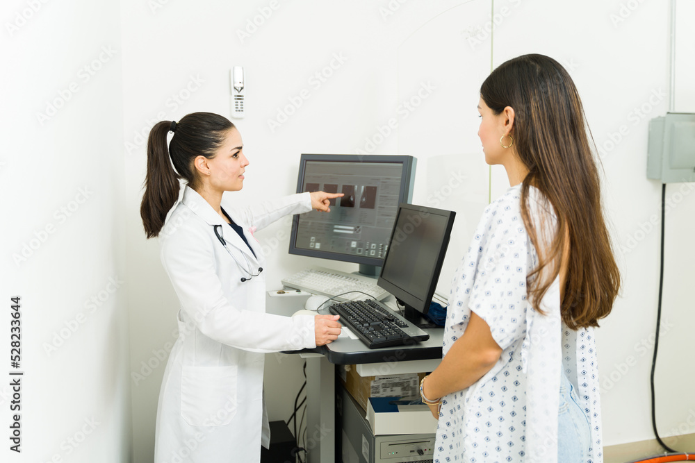 Doctor giving a diagnosis to a woman after getting a breast mammogram ...