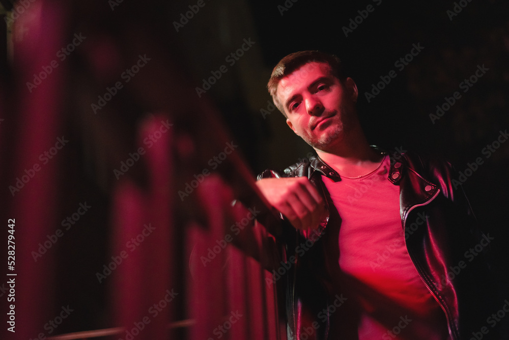Man in the neon lights on the night city streets. Stock Photo | Adobe Stock