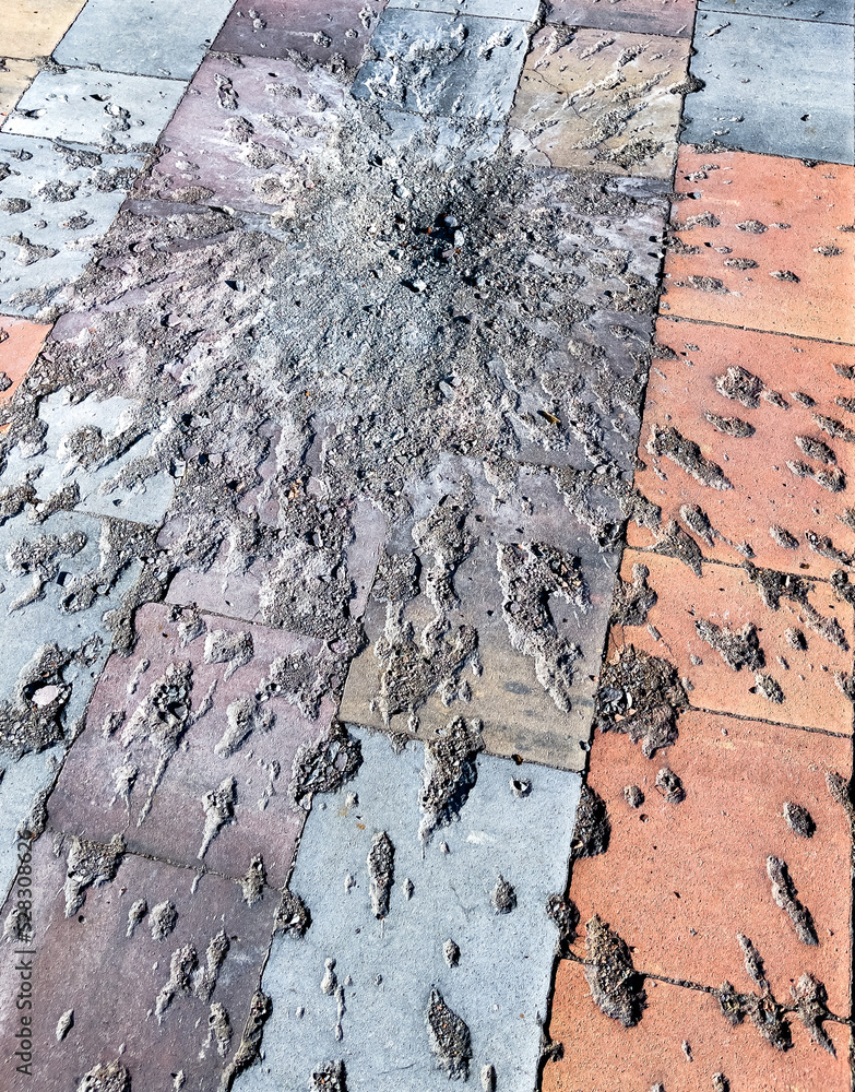 Traces on the pavement tile from the explosion of a mortar shell Stock ...