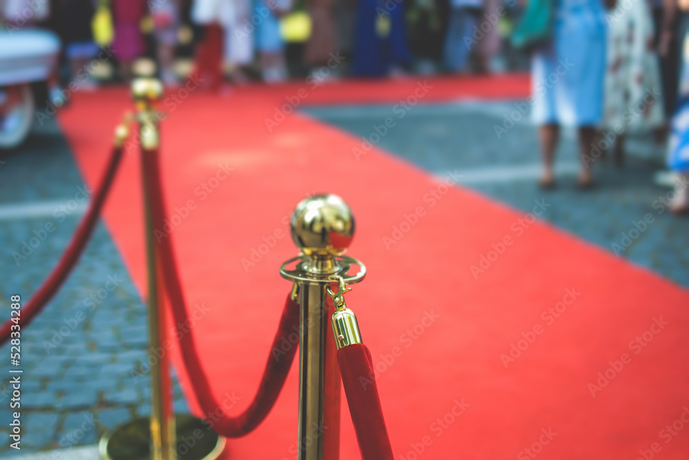 Red carpet with ropes and golden barriers on a luxury party entrance ...