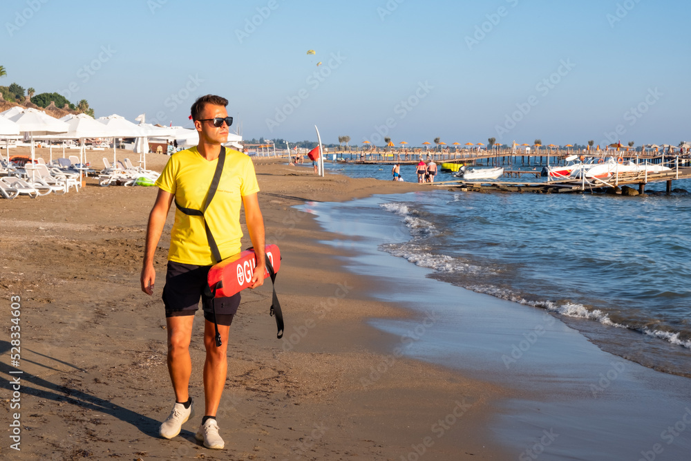 Lifeguard on the Mediterranean beach watching people in water. Safety ...